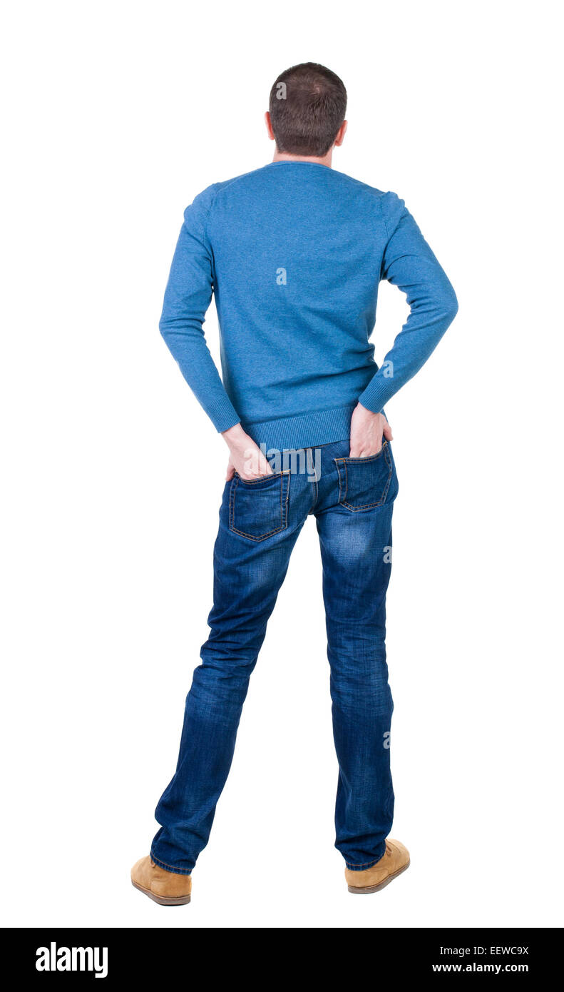 Back view of handsome man in blue pullover looking up. Standing young ...