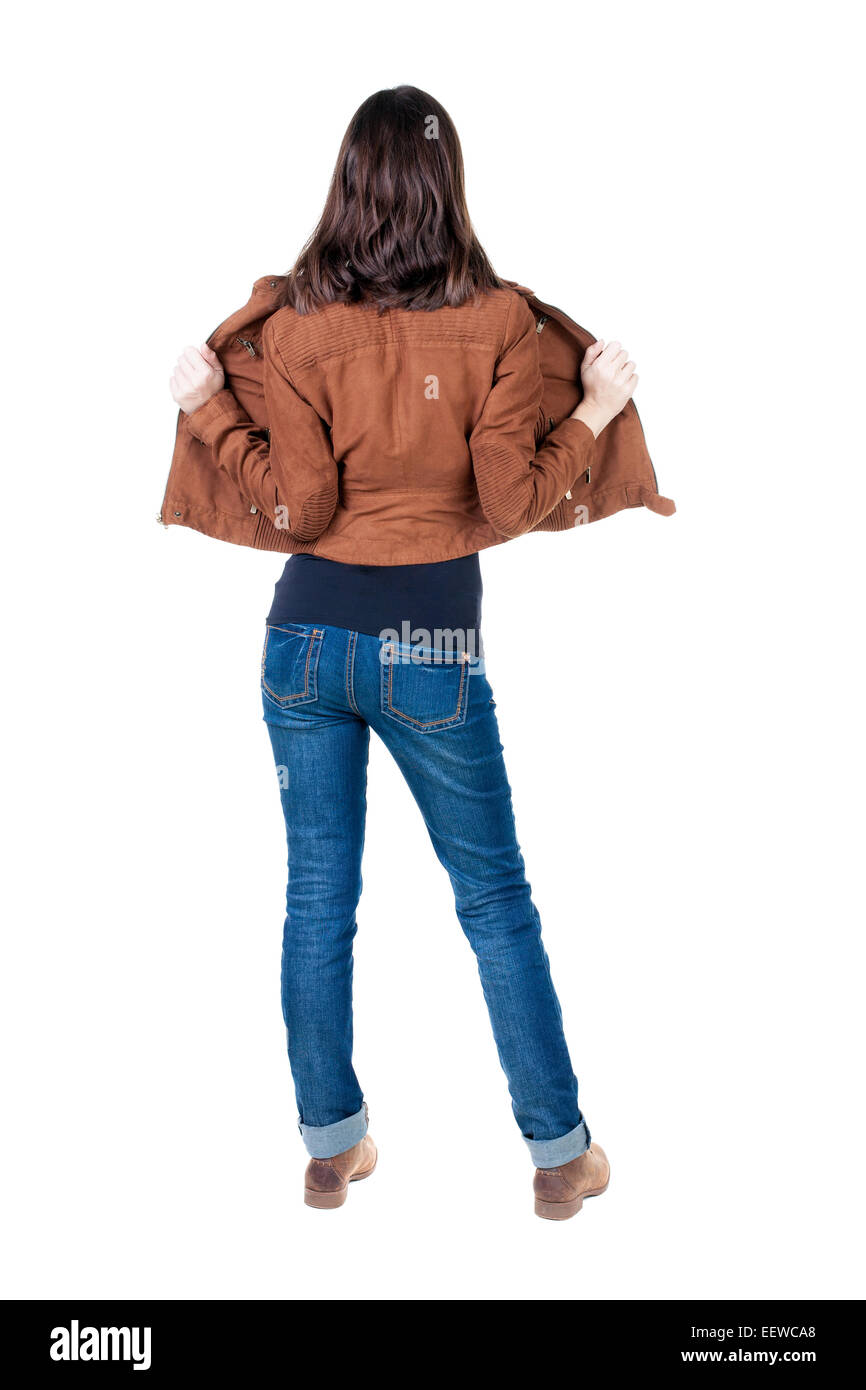 back view of standing young beautiful brunette woman in brown jacket ...