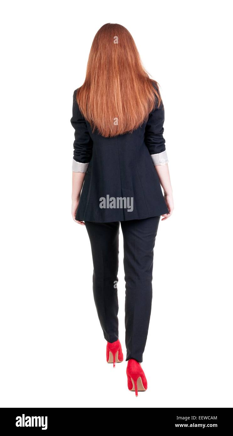 walking red head business woman. back view. going young girl in suit ...