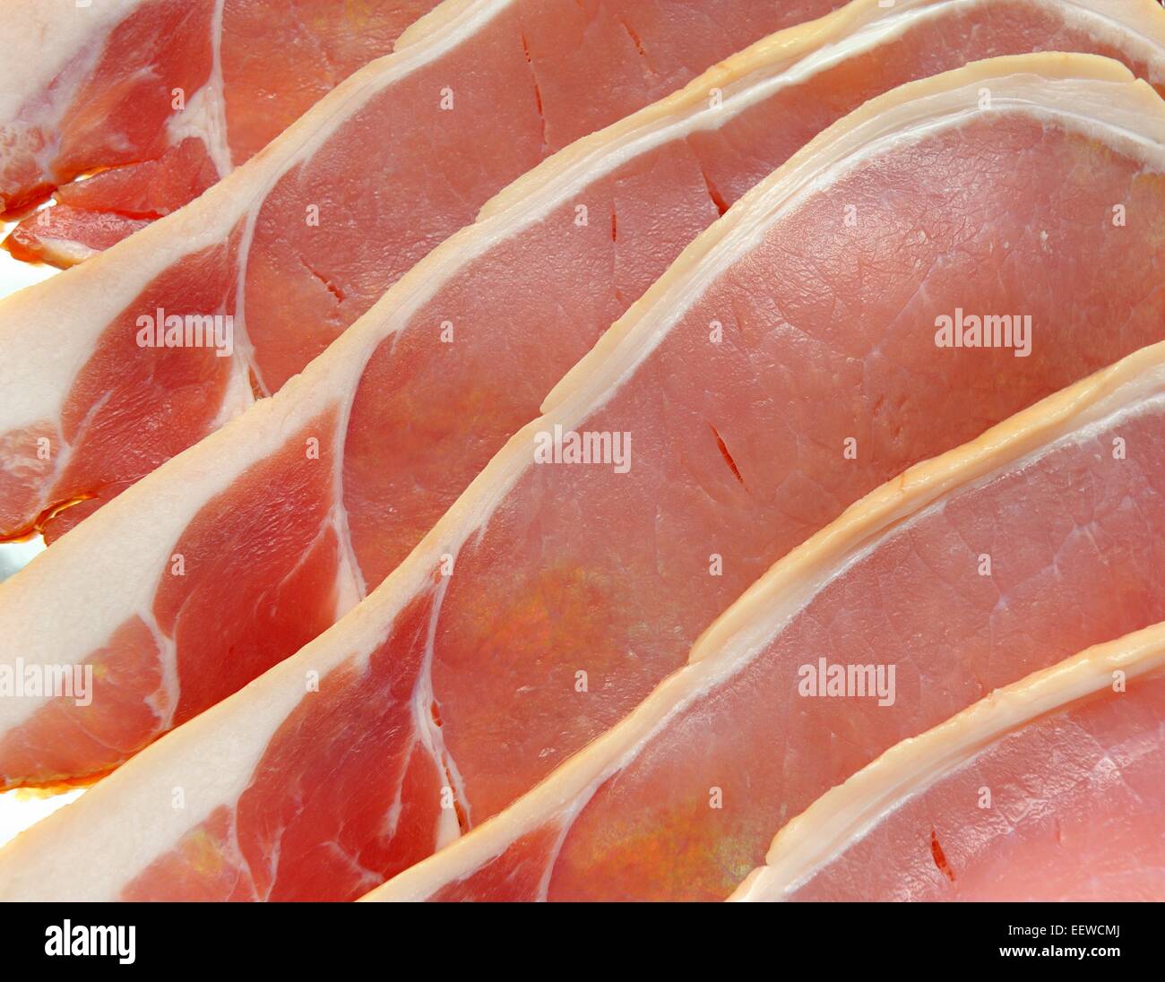 Rashers of raw uncooked smoked bacon Stock Photo - Alamy
