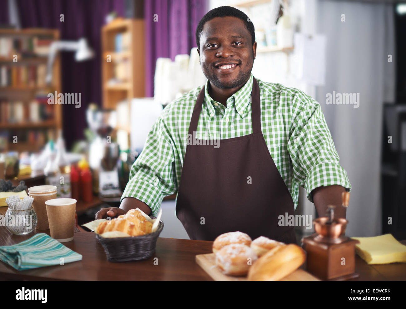 Handsome man selling pastry in bakery shop Stock Photo - Alamy