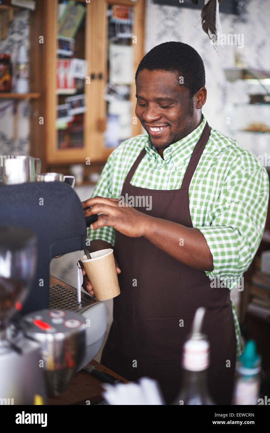 Young man working in coffee shop Stock Photo - Alamy