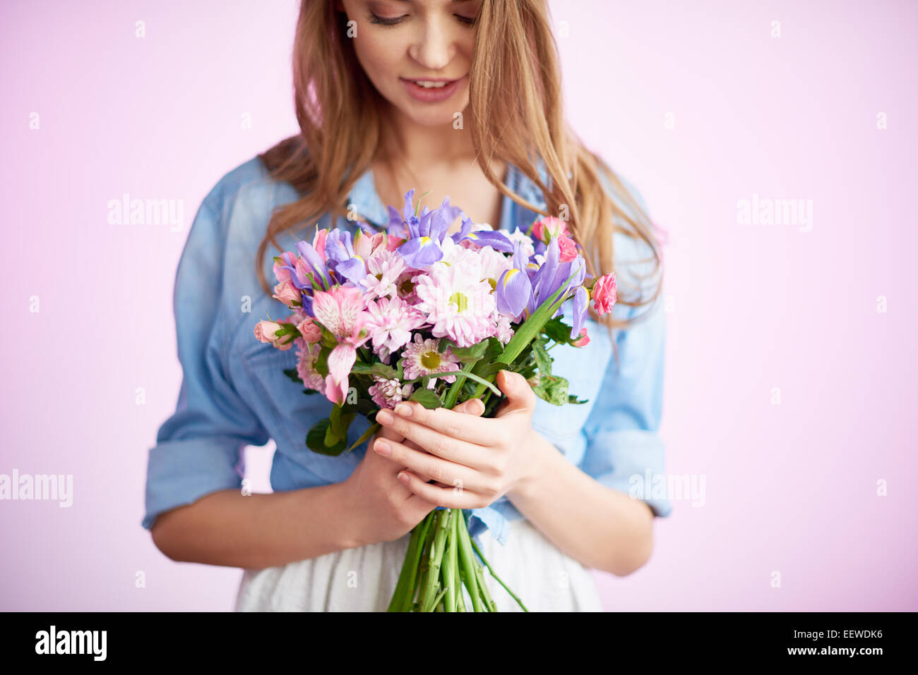Fragile female looking at floral bouquet Stock Photo - Alamy