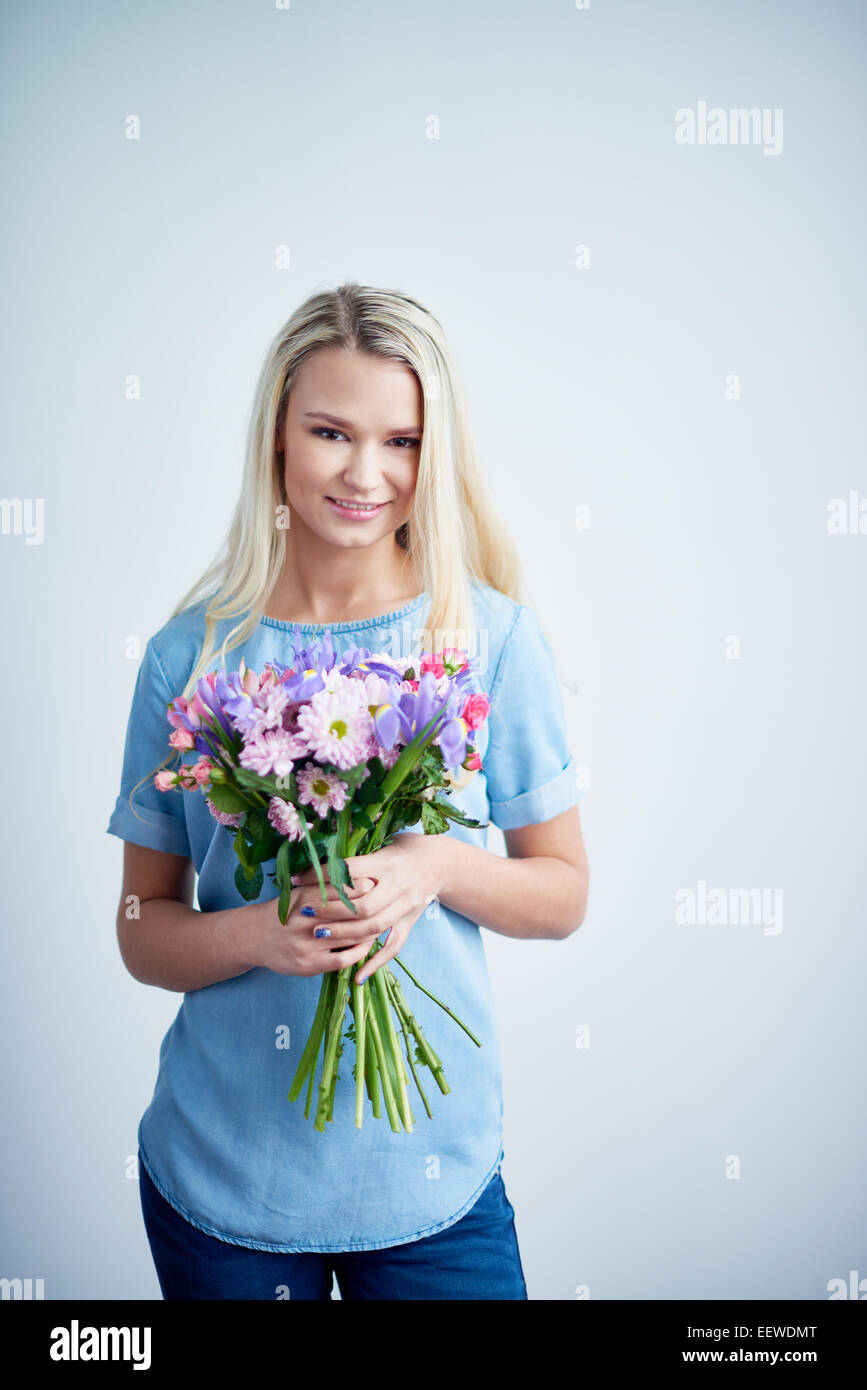 Cute smiling girl with various flowers Stock Photo - Alamy