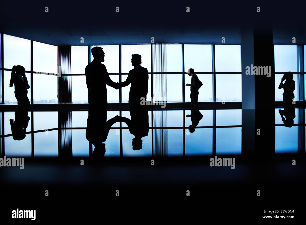 Silhouette group business people handshake hi-res stock photography and ...