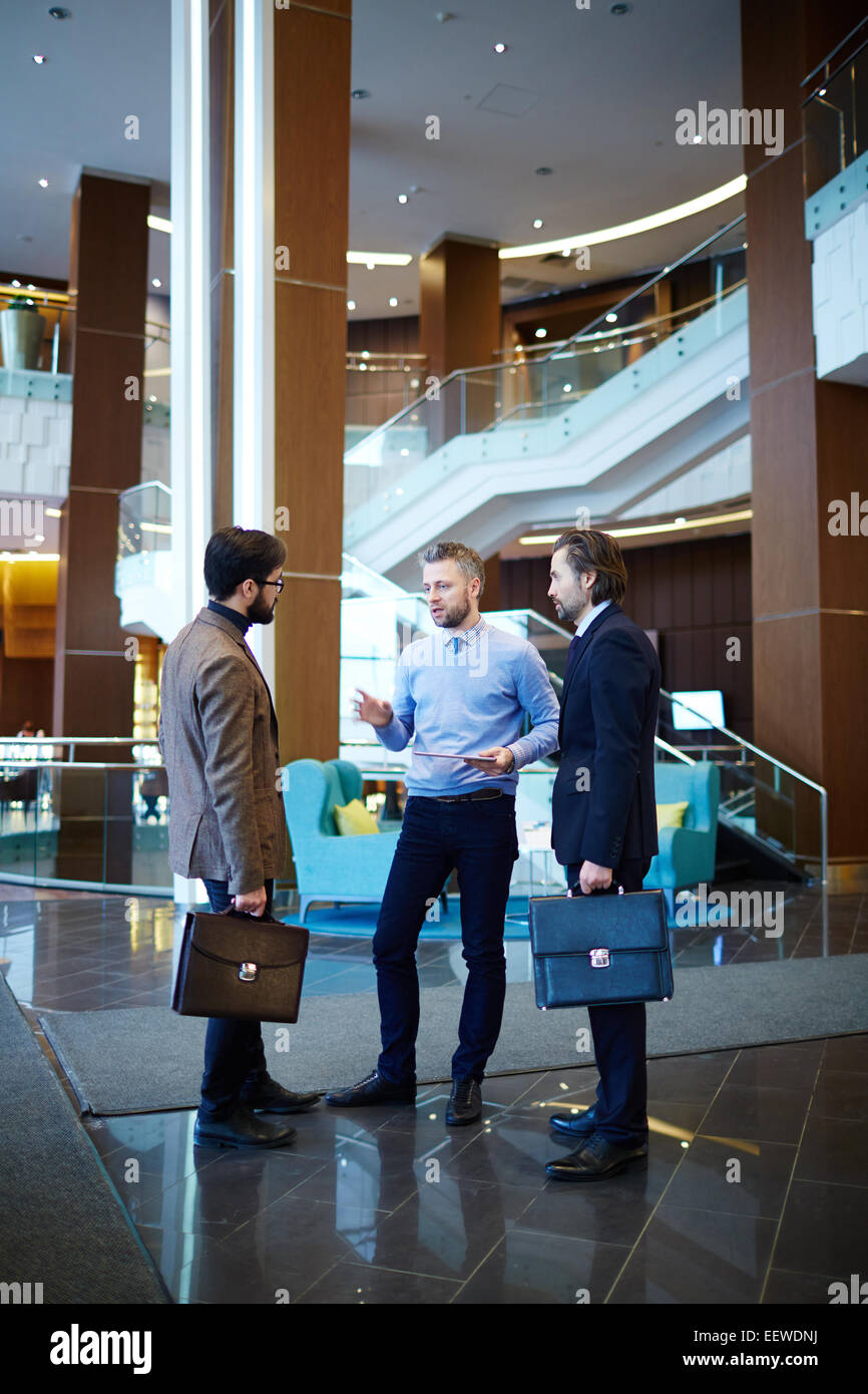Male managers having conversation in office Stock Photo - Alamy