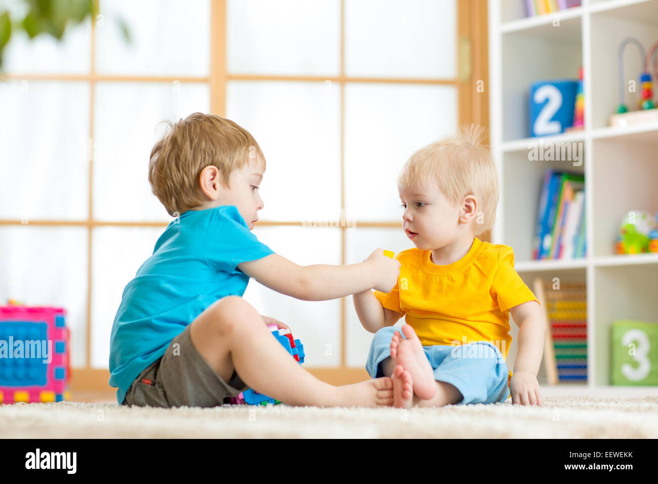 kids play together with educational toys Stock Photo - Alamy