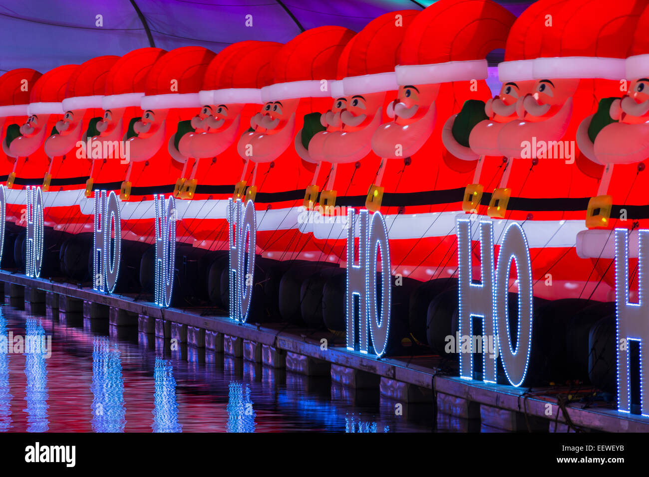 Brightly lit inflated Santa Claus with the words "HO, HO, HO" on a ...