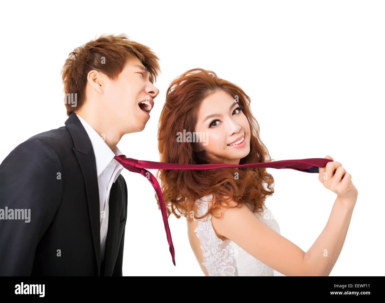 bride pulling on groom tie for control concept Stock Photo - Alamy