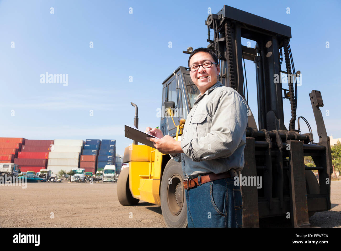 happy stacker driver writing on a document Stock Photo - Alamy