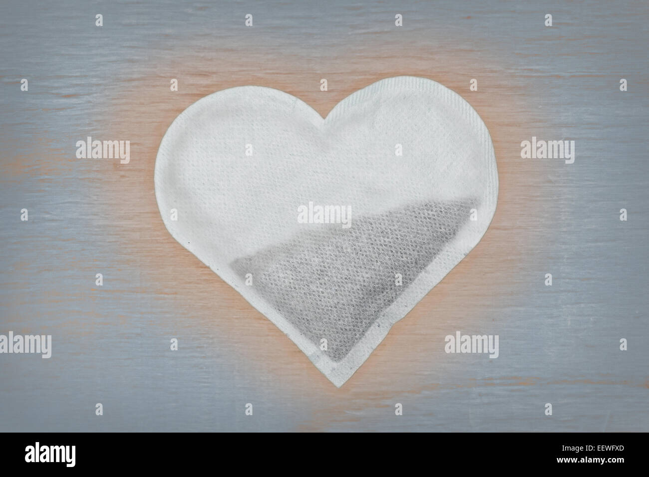 heart shaped tea bag on blue wooden background Stock Photo - Alamy