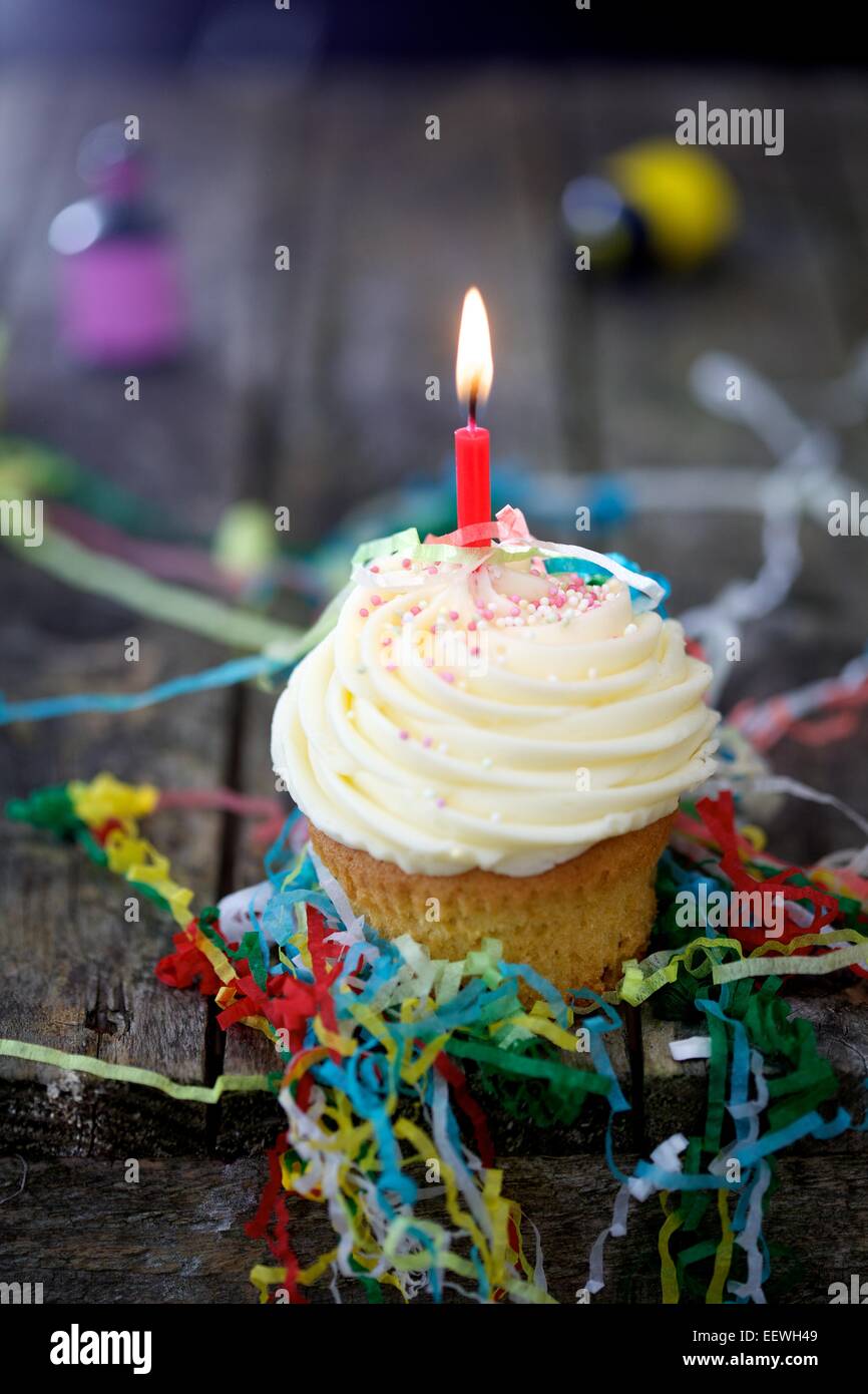 cup cake on table with lighted candle Stock Photo - Alamy