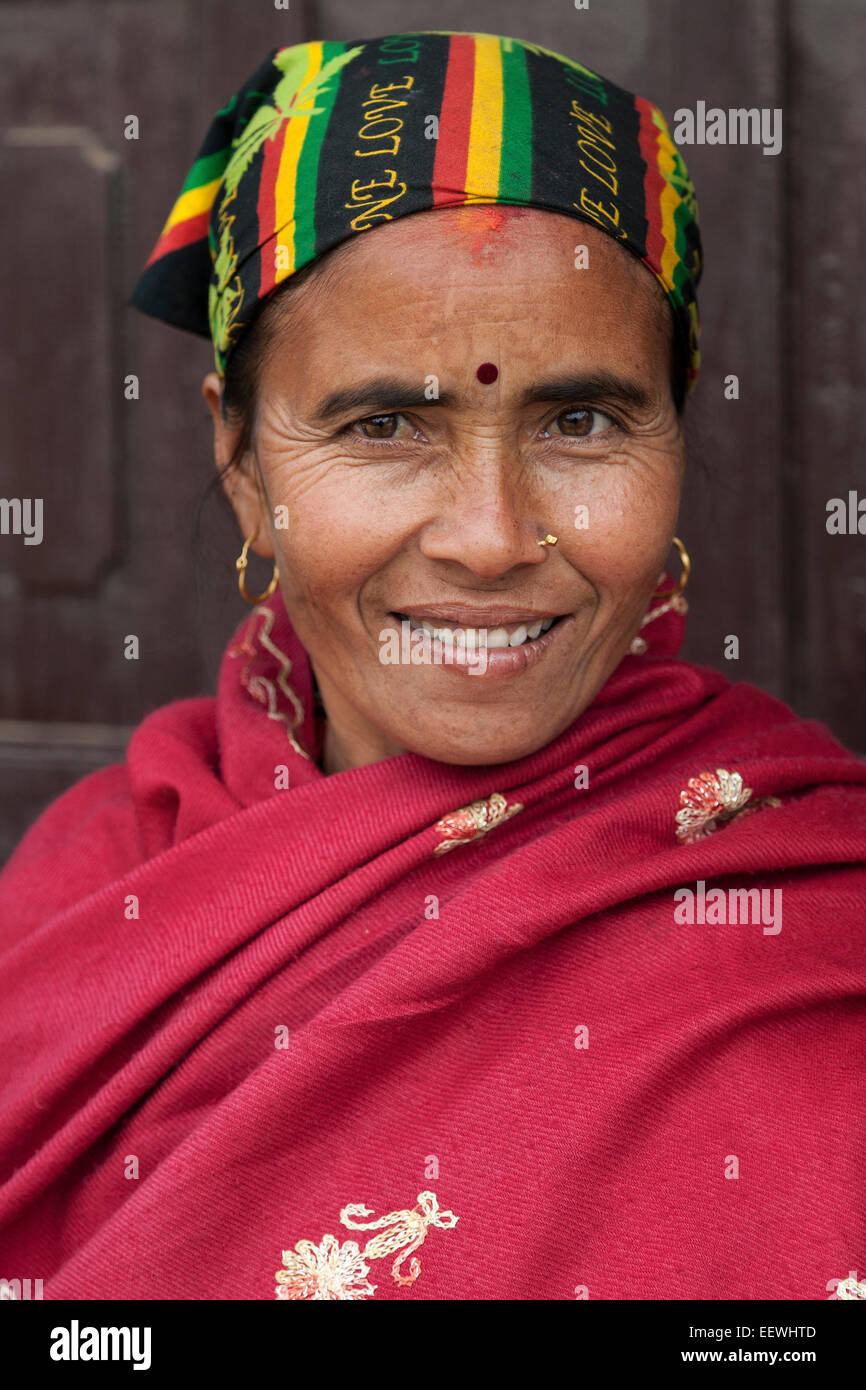 Nepalese woman with colourful headscarf and red cape, portrait ...