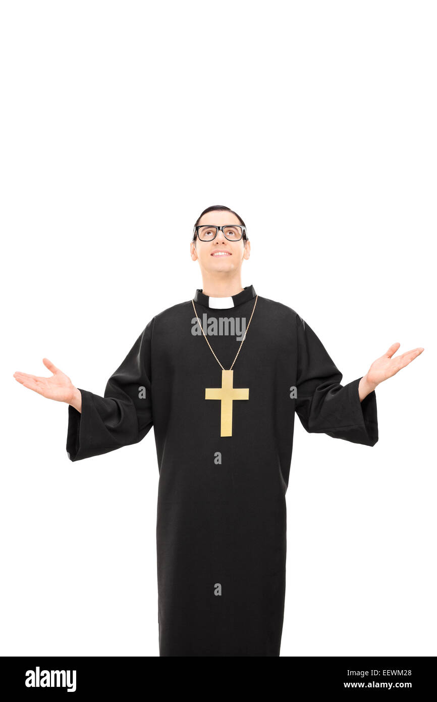Vertical shot of a young catholic priest looking up isolated on white ...