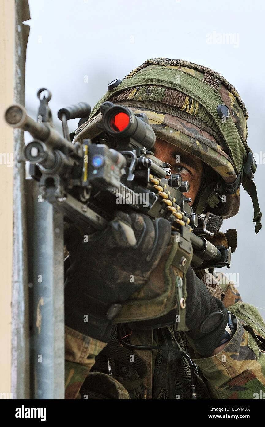 A Dutch soldier fires his machine gun during NATO exercise Allied ...