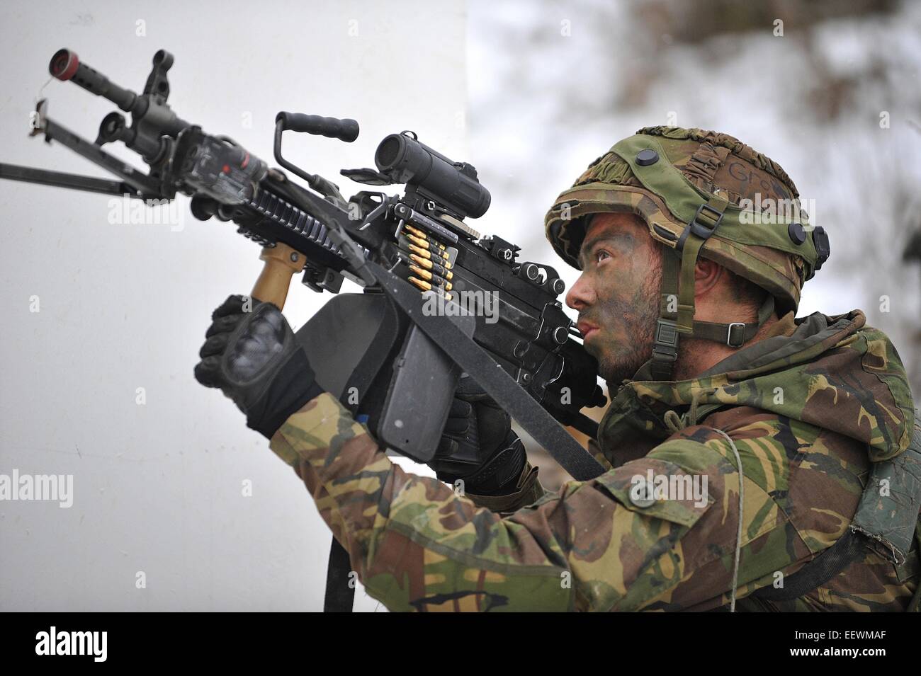 A Dutch soldier fires his machine gun during NATO exercise Allied ...