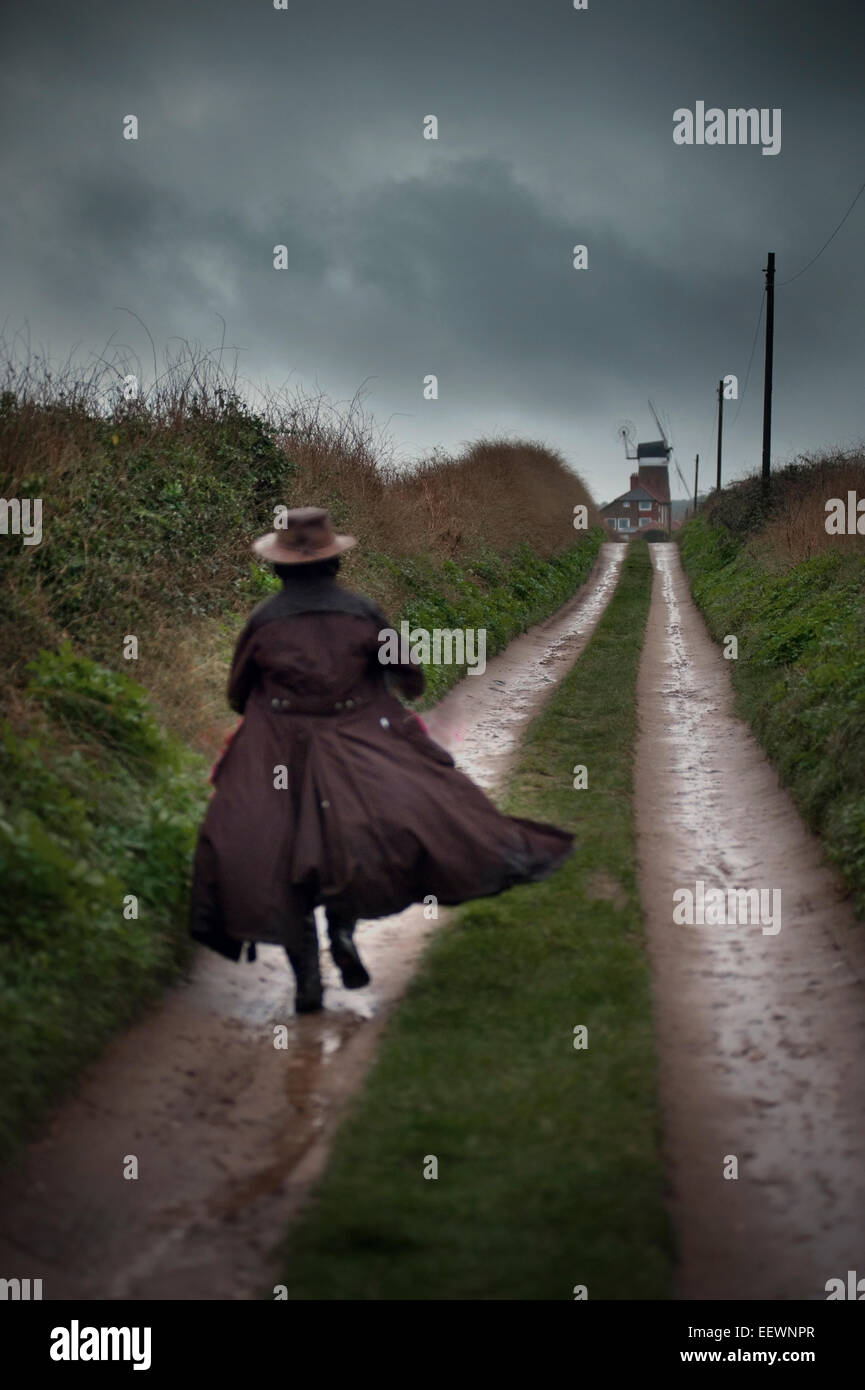 women running down rainy country lane Stock Photo - Alamy