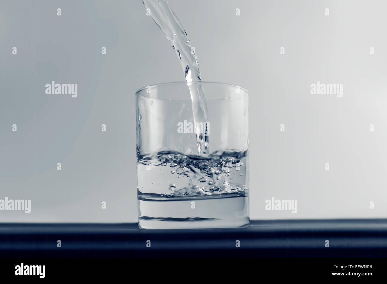 Filling glass of water Stock Photo - Alamy