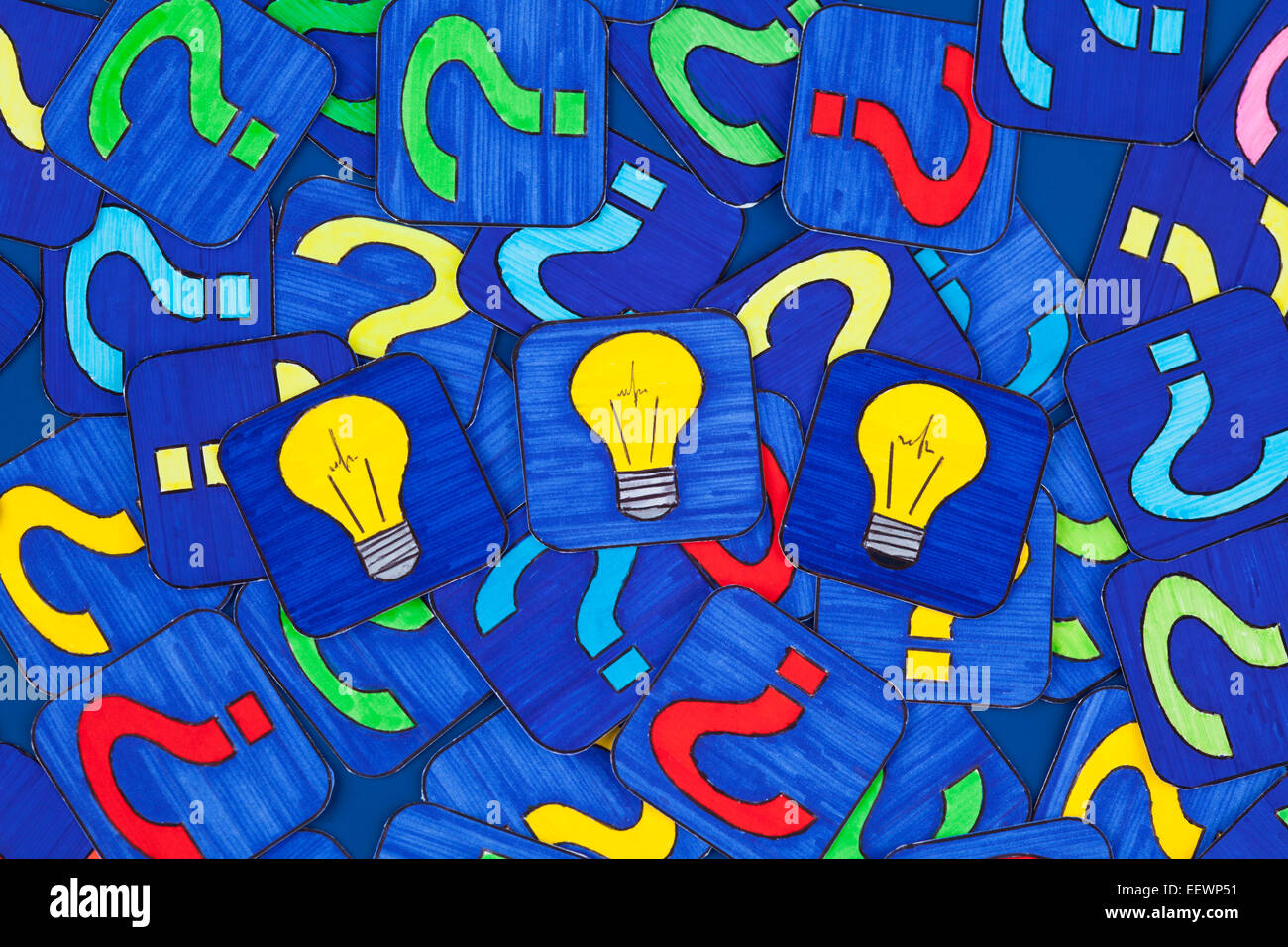 Three yellow light bulbs and a lot of question marks on blue background ...