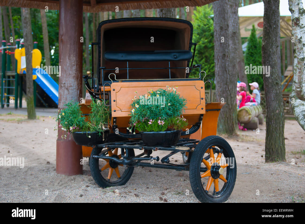 Ancient coach and flower beds on the playground. Garden Stock Photo - Alamy