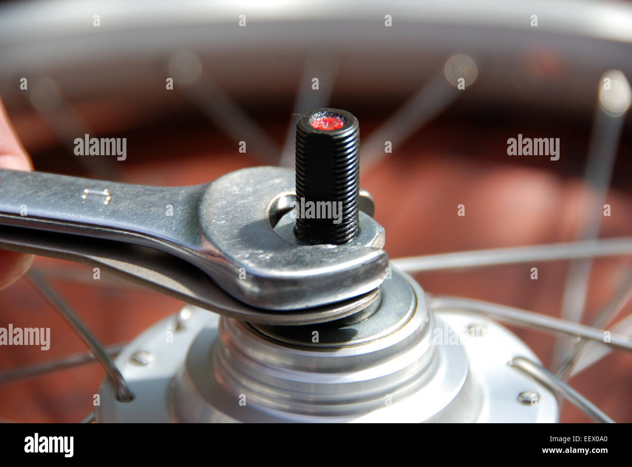 Adjusting cones on bicycle wheel Stock Photo - Alamy