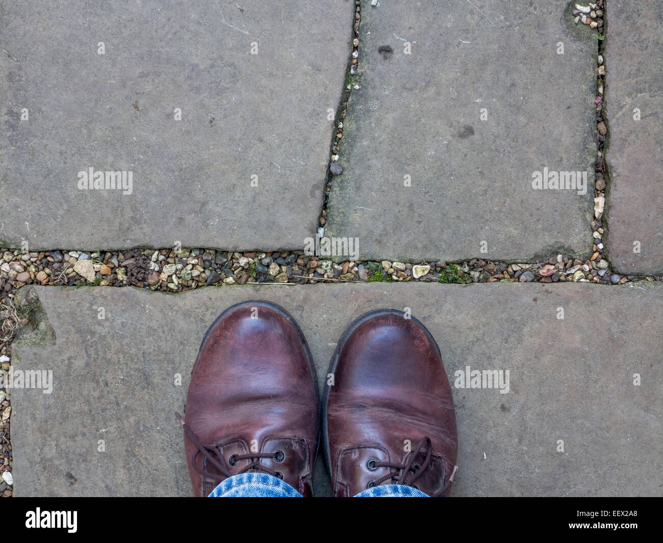 Shoes on paving slabs Stock Photo - Alamy