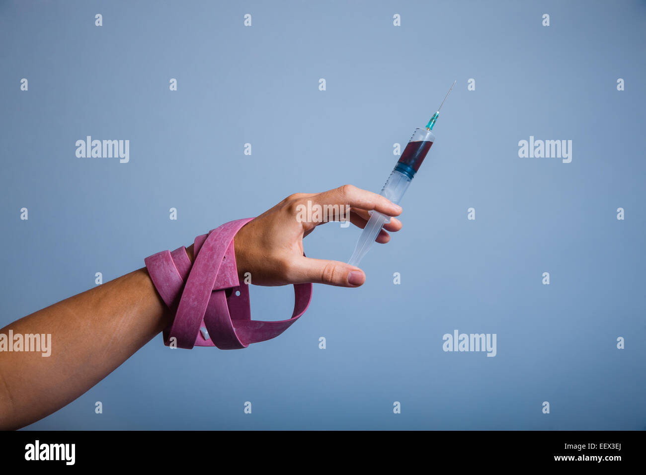 hand wound with a tourniquet holding syringe, drug addict on Stock ...