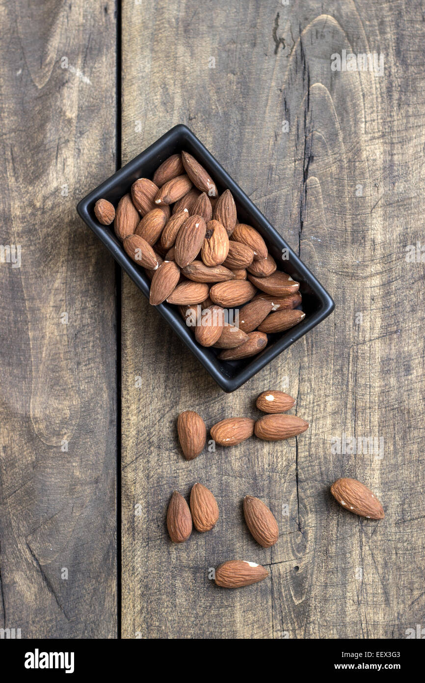 almonds in bowl on grained wood background, from above Stock Photo - Alamy