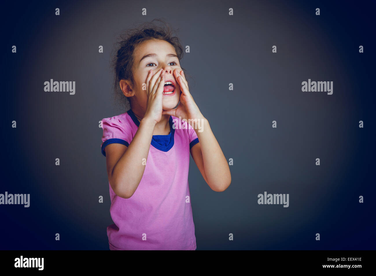 baby girl calls for help from the person hands on a gray backgro Stock ...