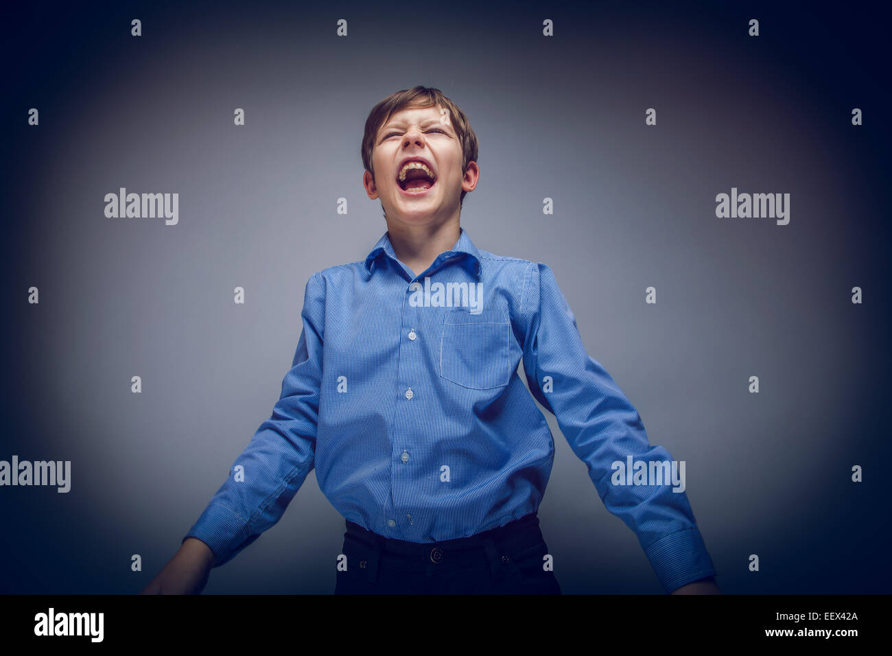 Portrait of a boy brown European appearance shouting on gray bac Stock ...