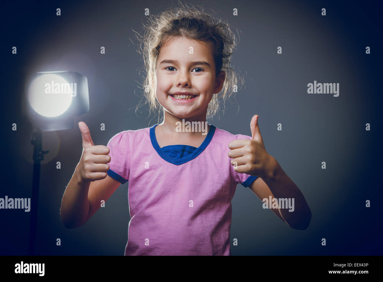 baby girl showing gesture yes on gray background cross process Stock ...