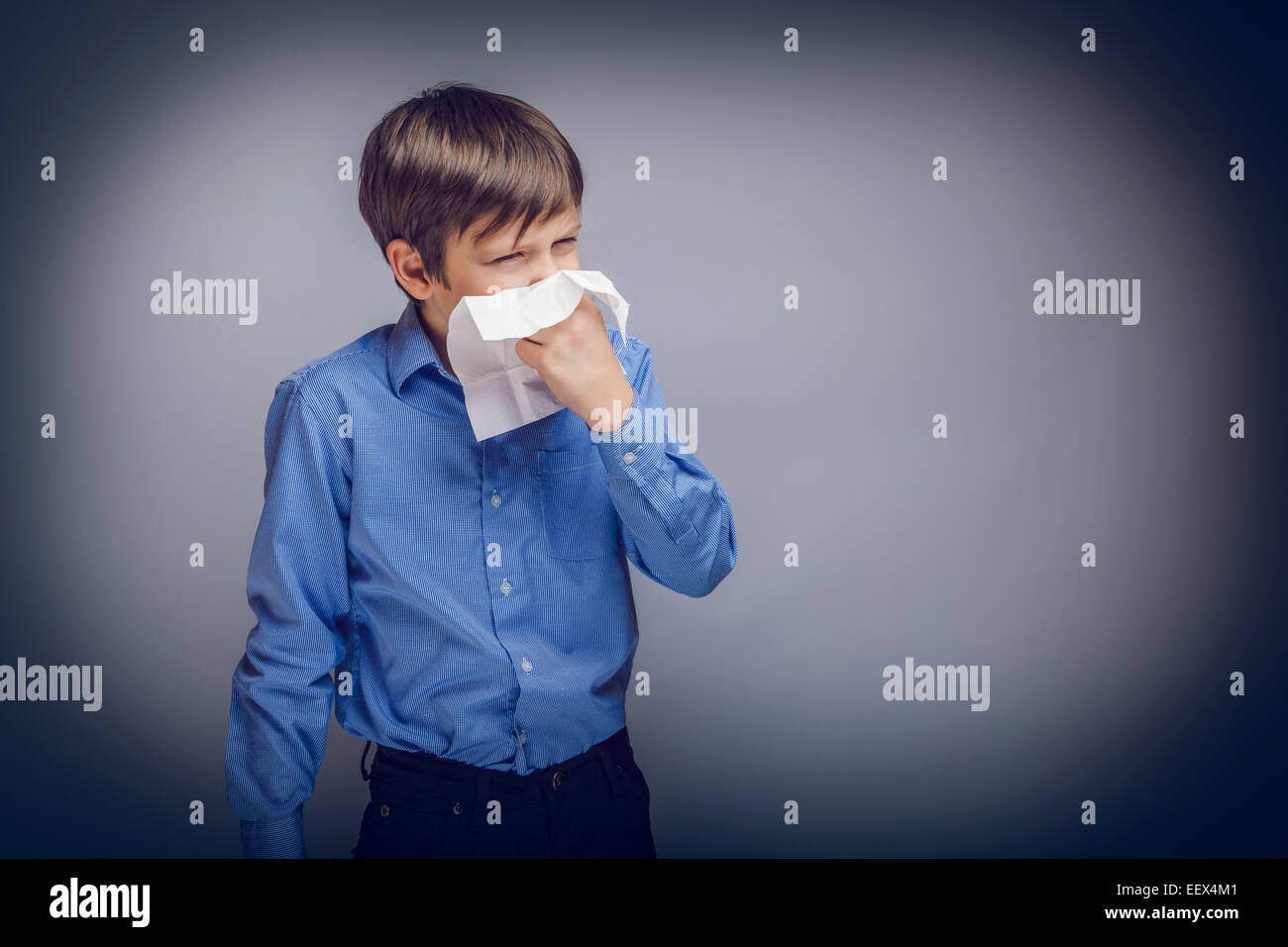 teenager boy of 10 years European appearance sick sneezing in Stock ...