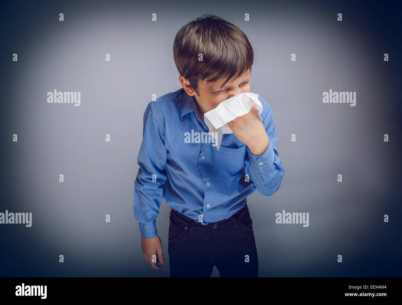 teenager boy of 10 years European appearance sick sneezing in Stock ...