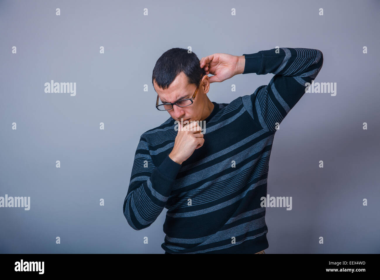 European-looking man years in glasses, thinking Stock Photo - Alamy