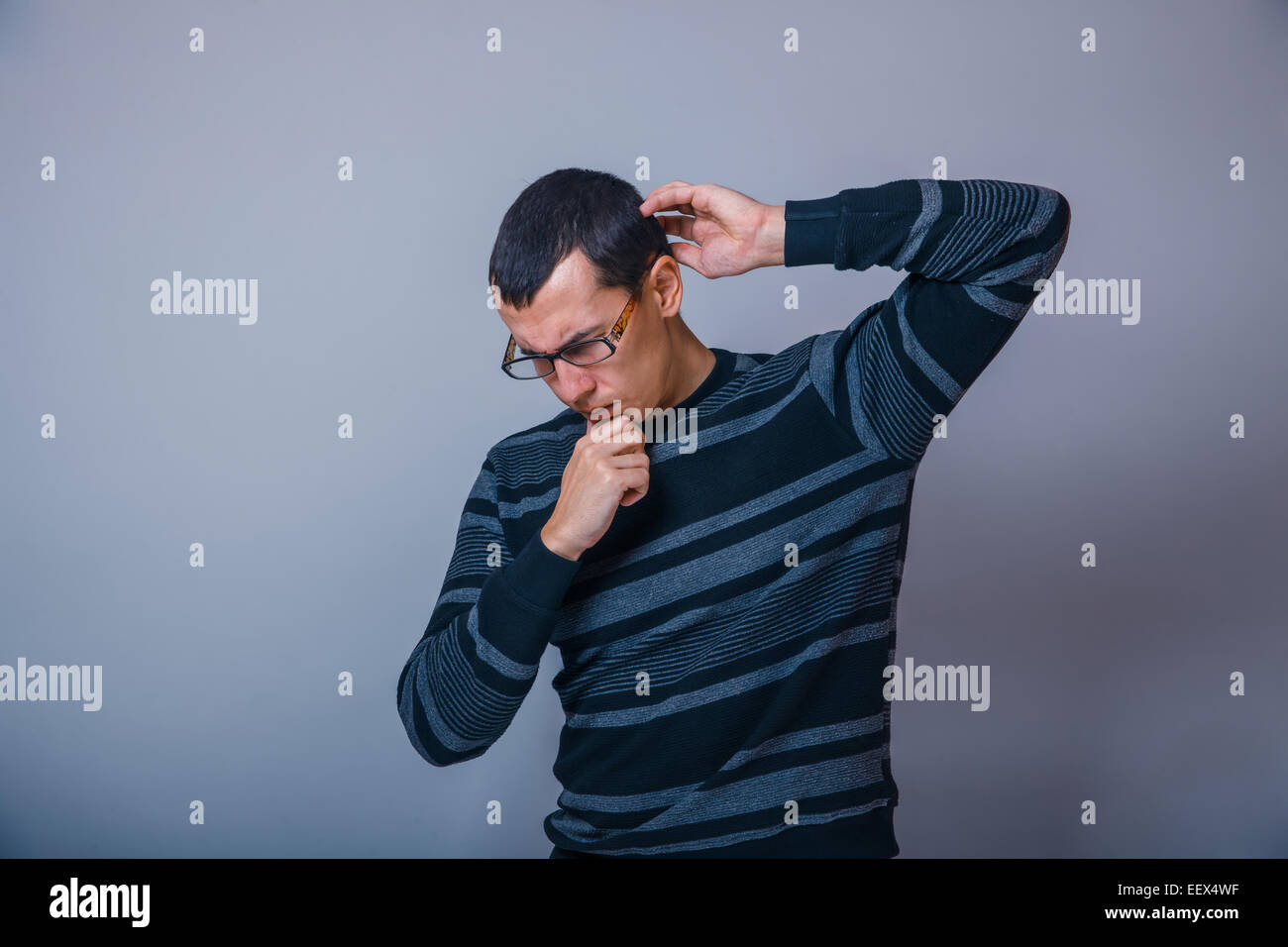 European-looking man years in glasses, thinking Stock Photo - Alamy
