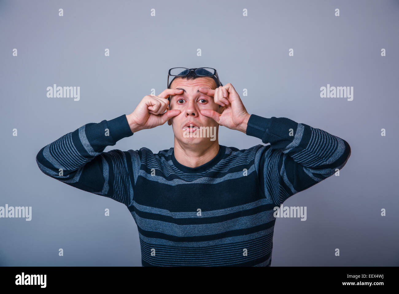 European-looking man of 30 years opened eyes with his hands on a Stock ...