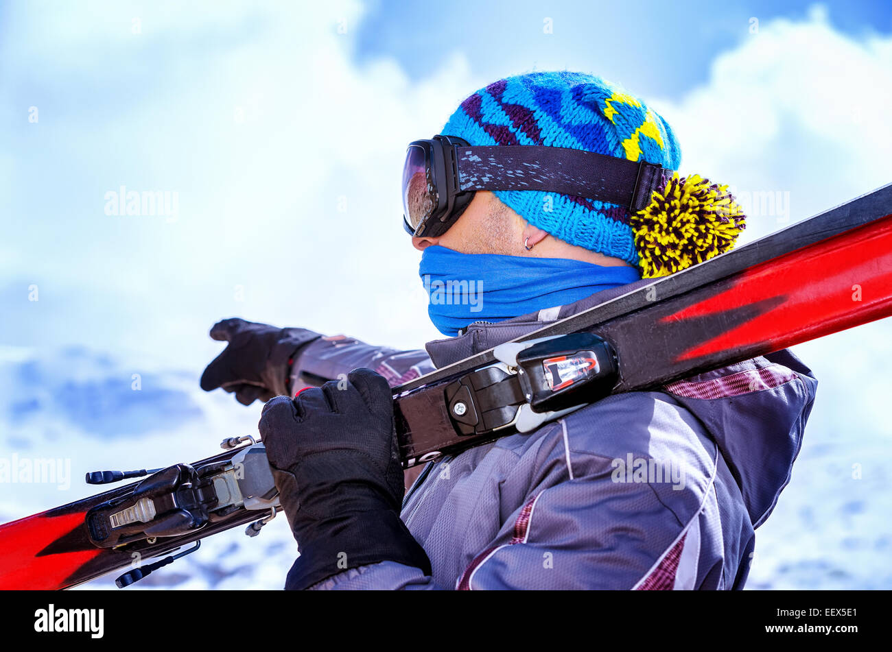 Ski trainer standing on the top of mountain and showing direction ...