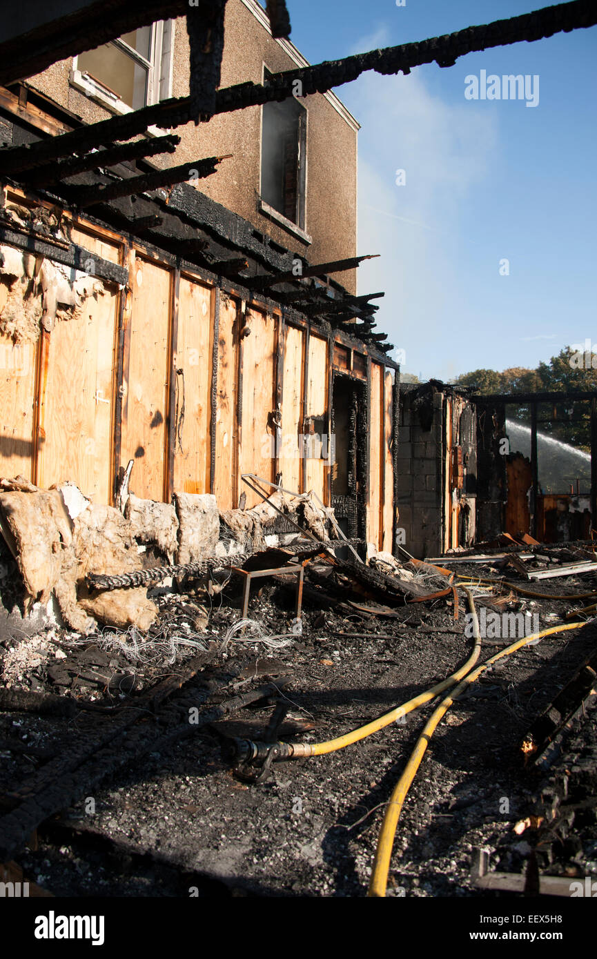 Burnt out fire house extension summer room hose Stock Photo - Alamy
