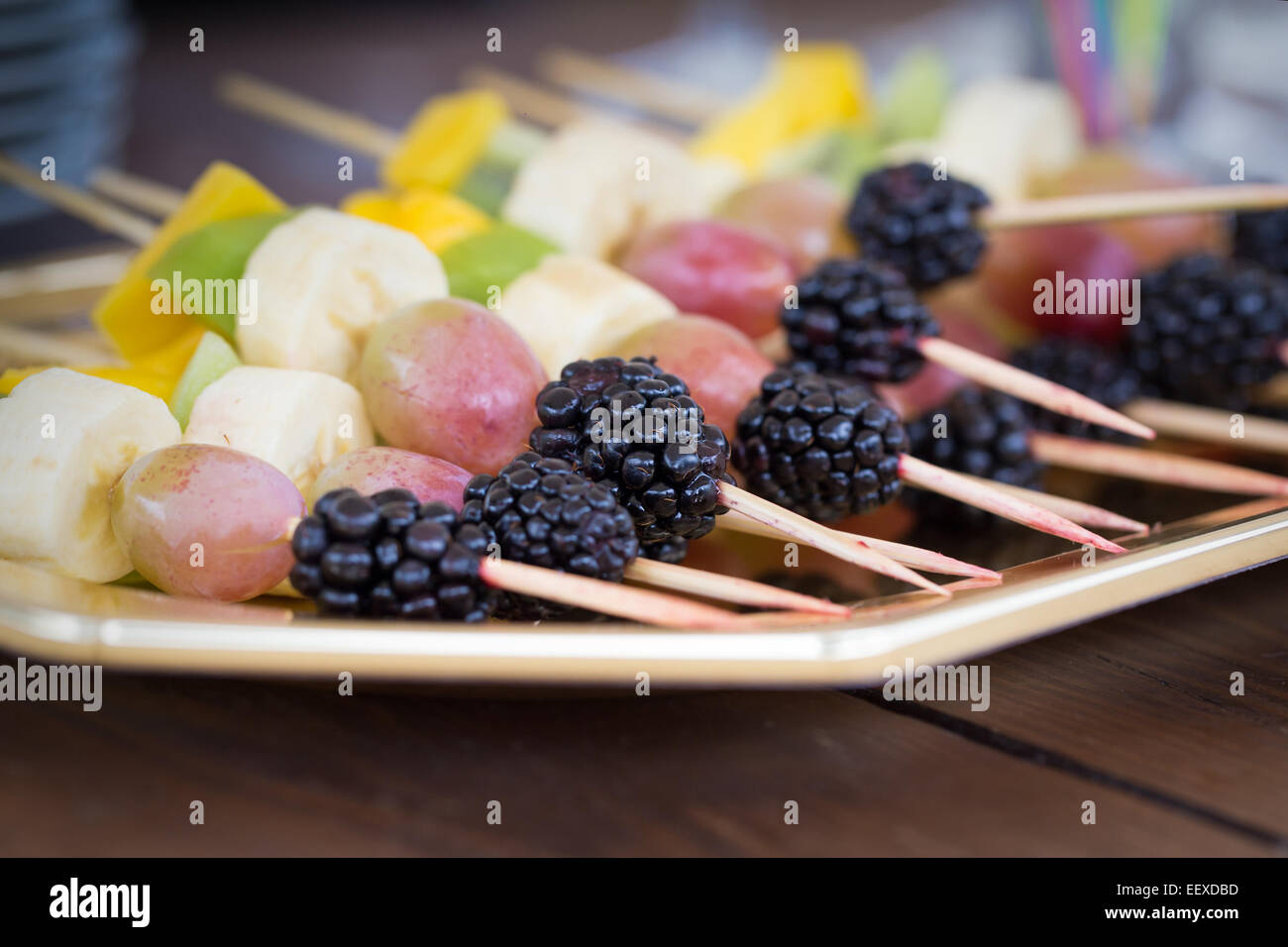 Fruits on a toothpick grapes, blackberries, banana Stock Photo - Alamy