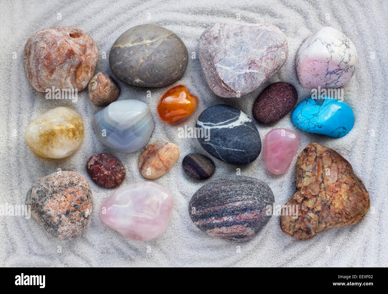 Precious sea stones lie on white quartz sand macro background Stock ...