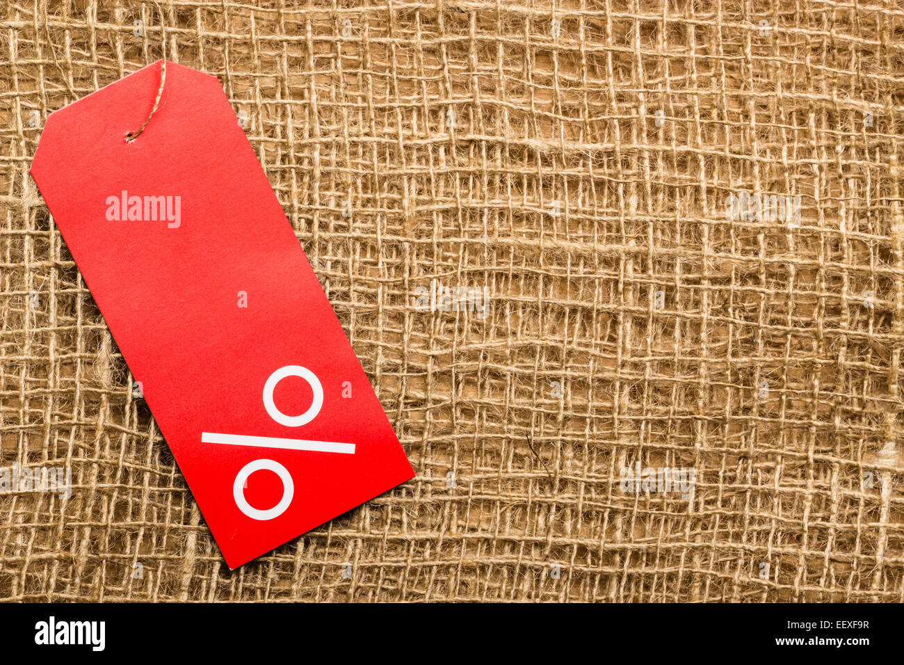 Shopping and sale concept. Red price label with percent sign on cloth ...