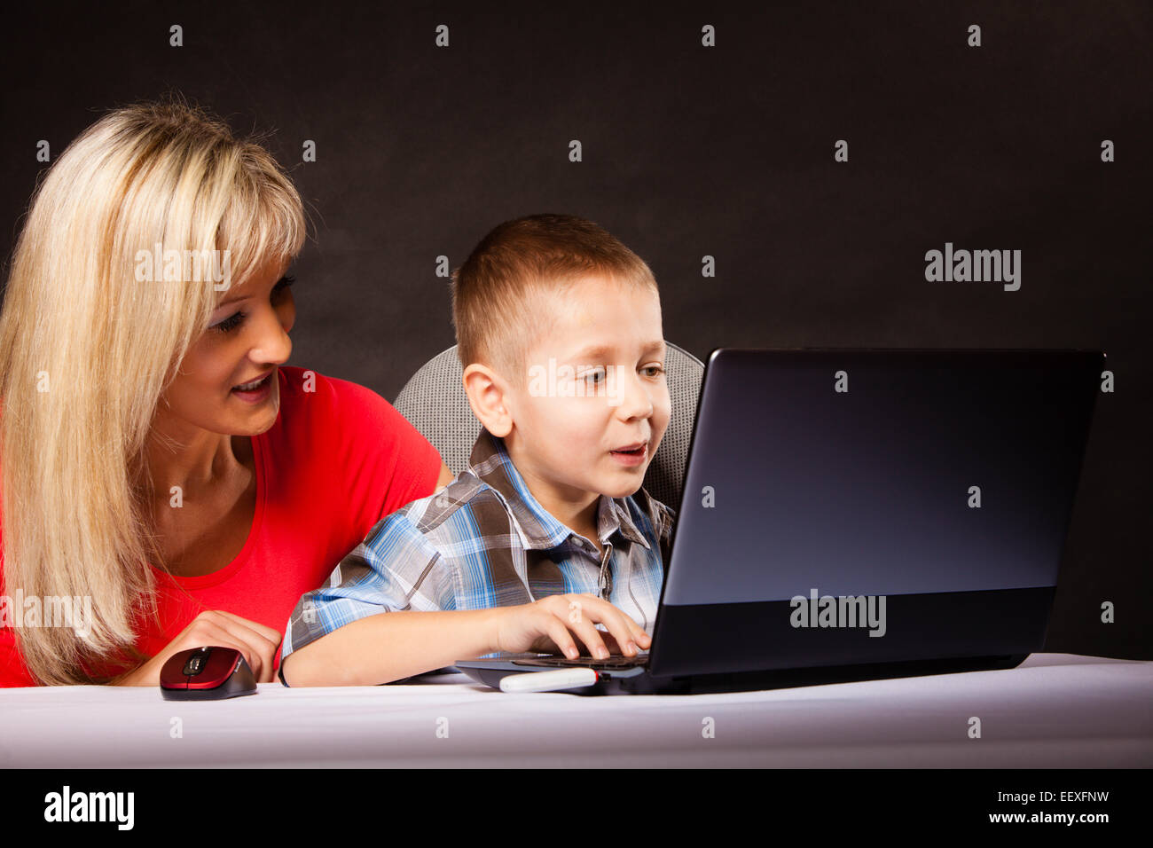 education, technology, internet and parenting concept - boy and mother ...