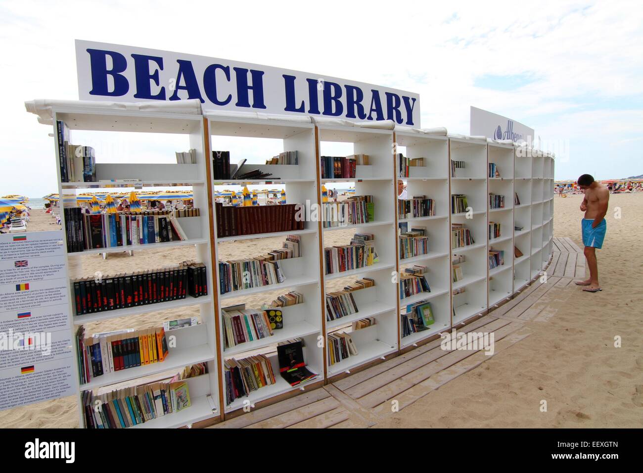 People look for and read books at the first ever free beach library ...
