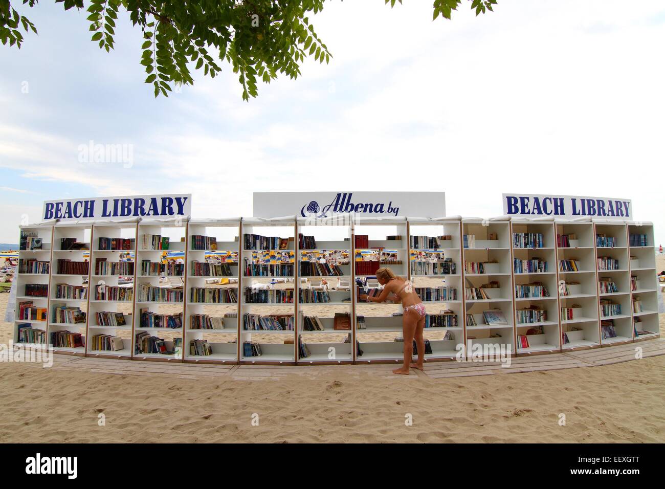 People look for and read books at the first ever free beach library ...