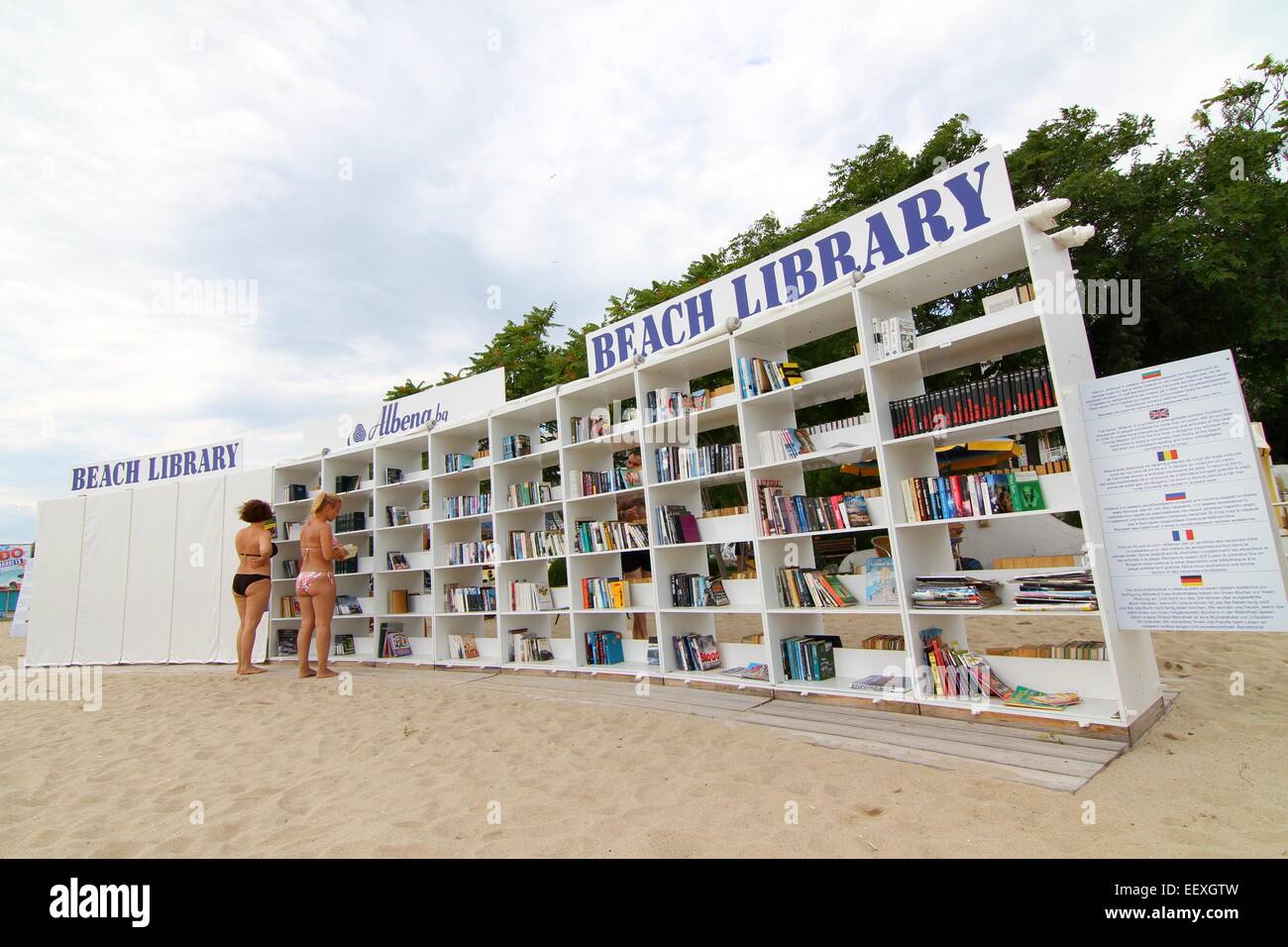 People look for and read books at the first ever free beach library ...