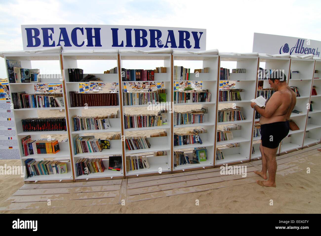 People look for and read books at the first ever free beach library ...
