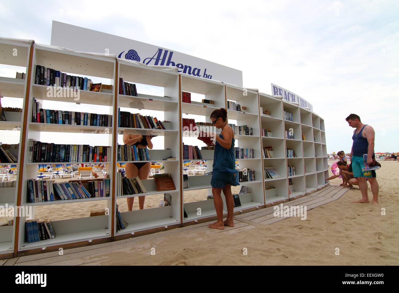 People look for and read books at the first ever free beach library ...