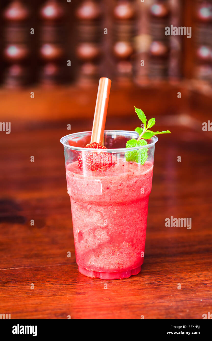 Cold Strawberry Slush in clear plastic glass Stock Photo - Alamy