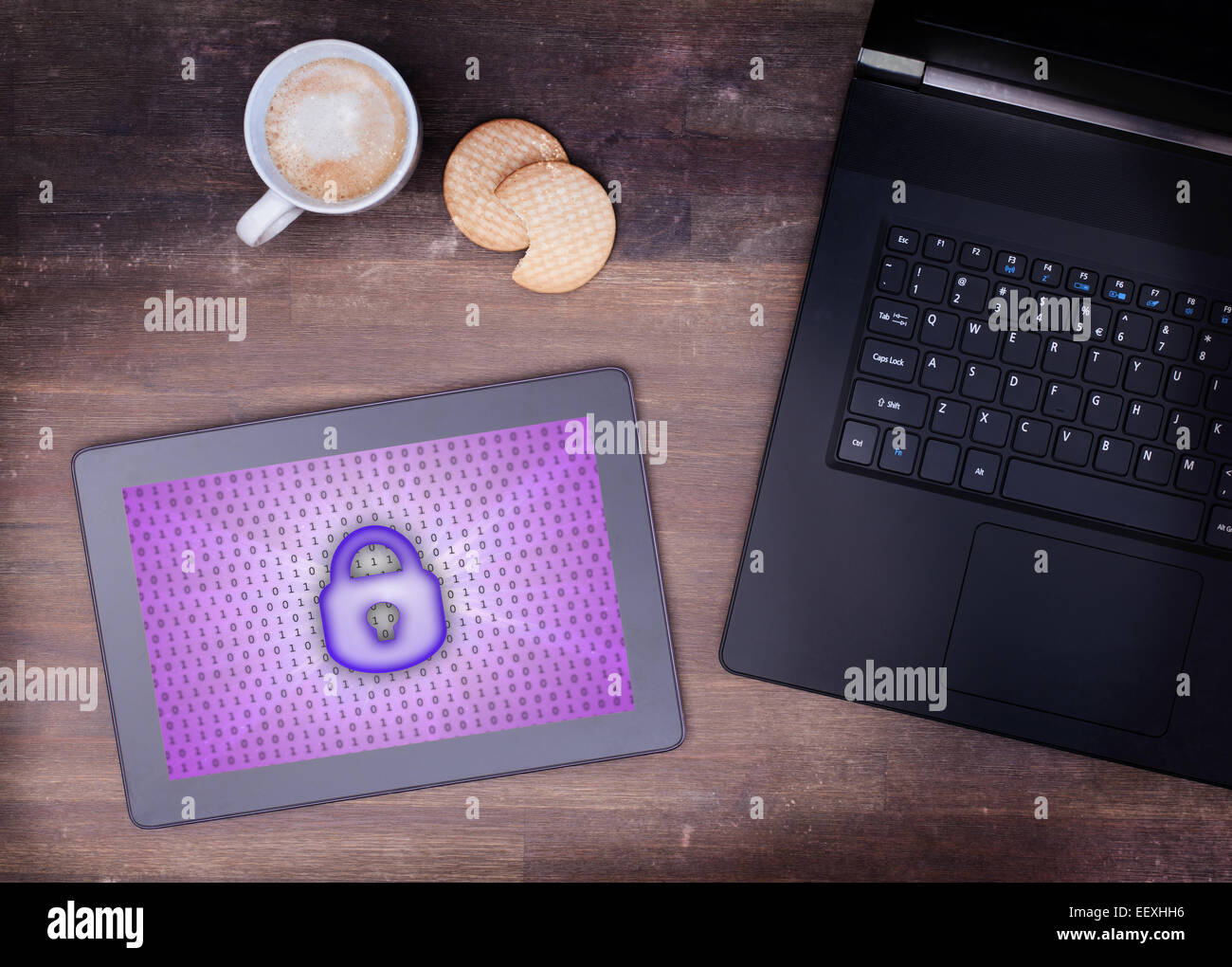 Tablet on a desk, concept of data protection, purple Stock Photo - Alamy