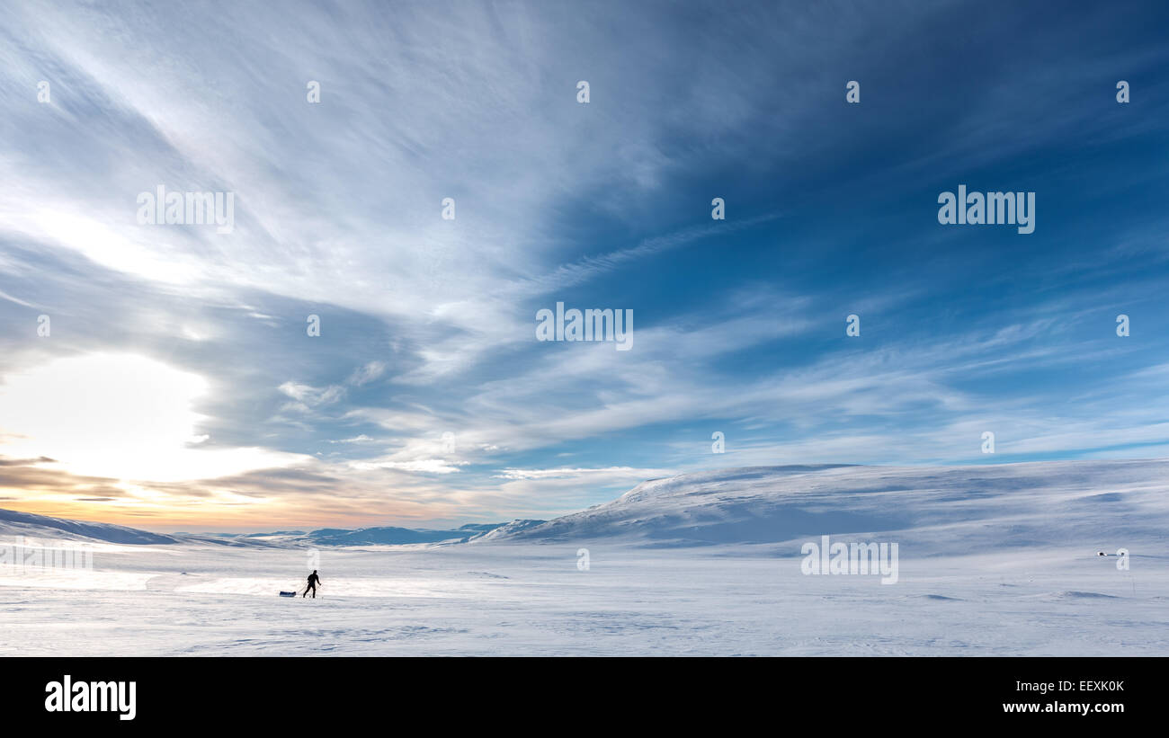 A skier with a Lapp's sledge skiing towards Halti fell, Enontekiö ...